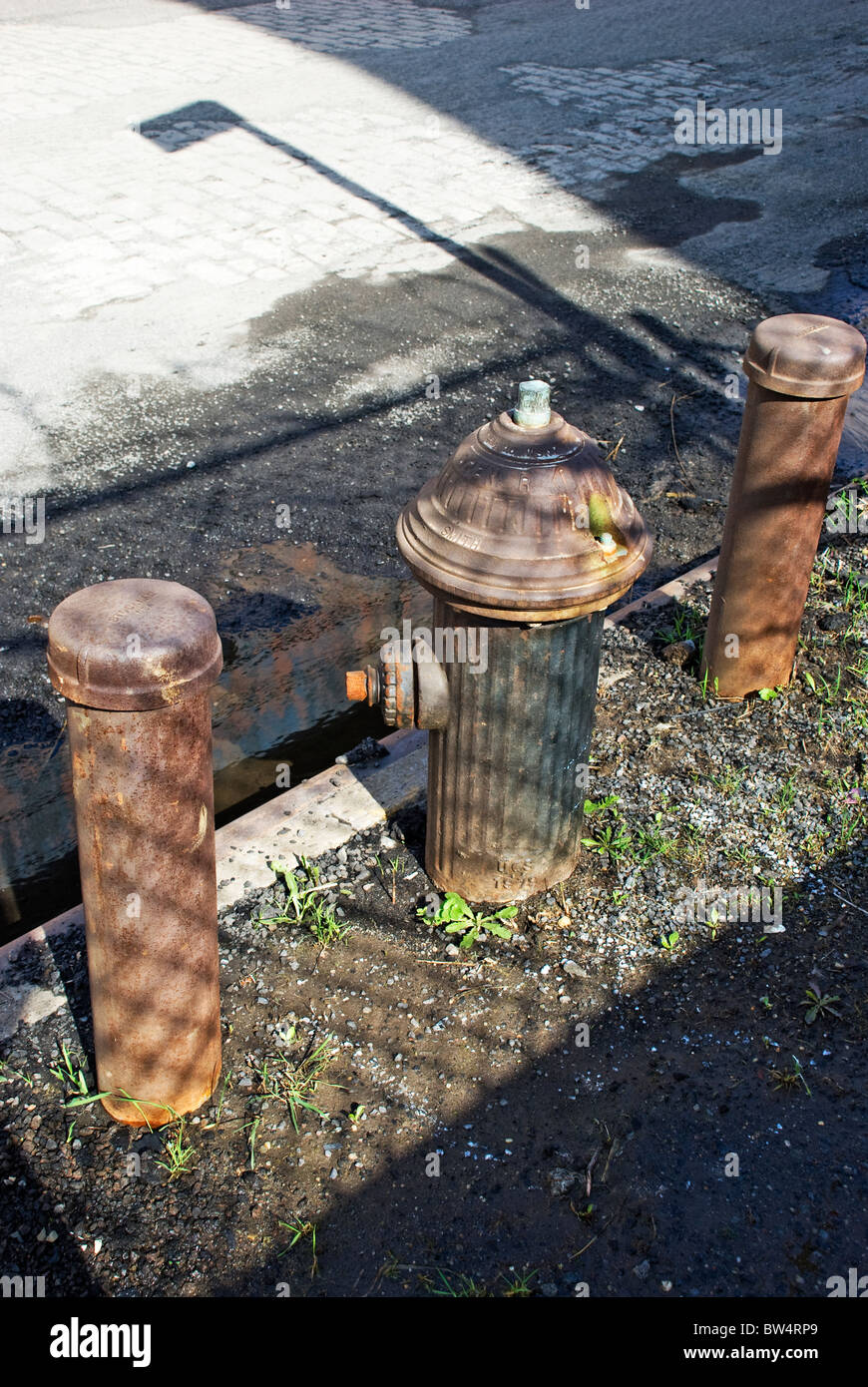 Street side fire hydrant protected by pipes on each side of it Stock ...