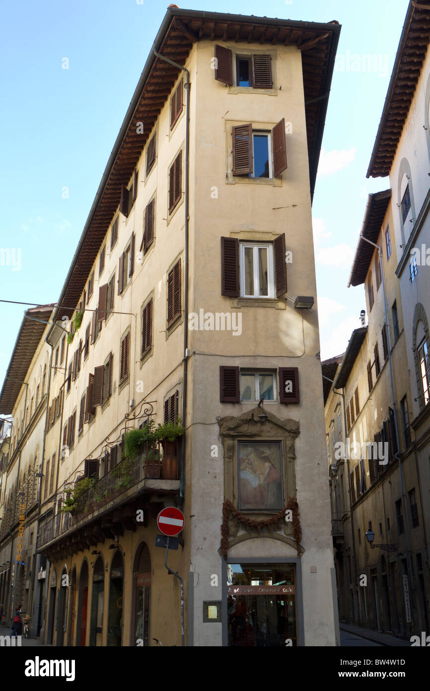 Tall and very narrow building on a street corner in Florence with a ...