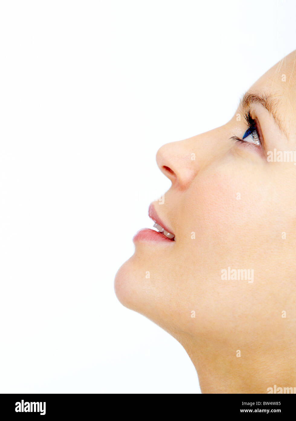 Profile of female looking upwards in isolation Stock Photo - Alamy