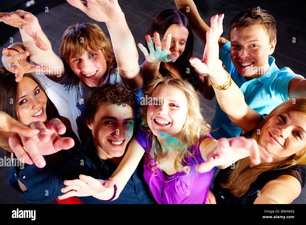 Photo of smiling friends dancing during the party Stock Photo - Alamy