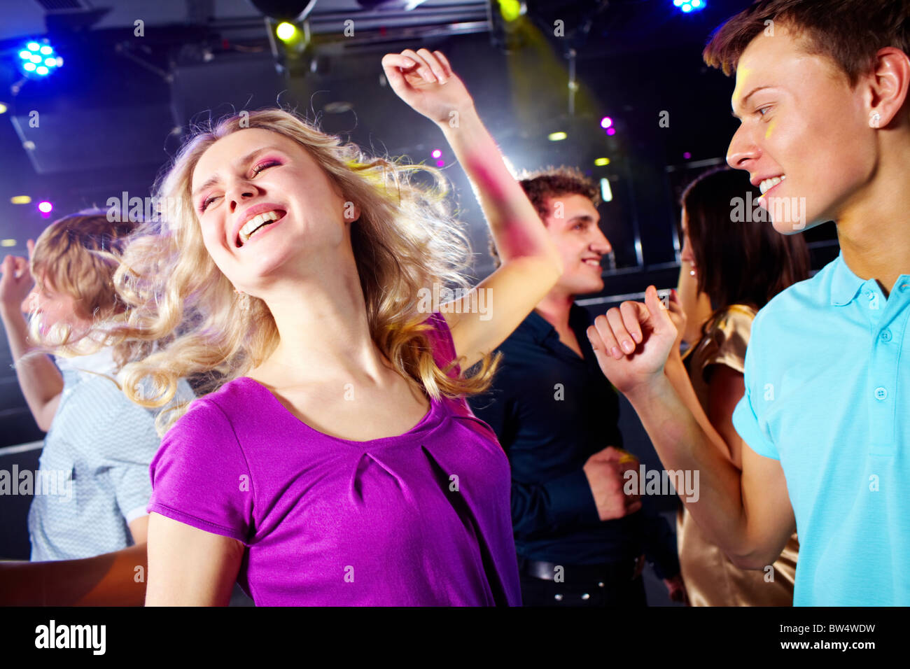 Photo of smiling friends dancing during the party Stock Photo - Alamy