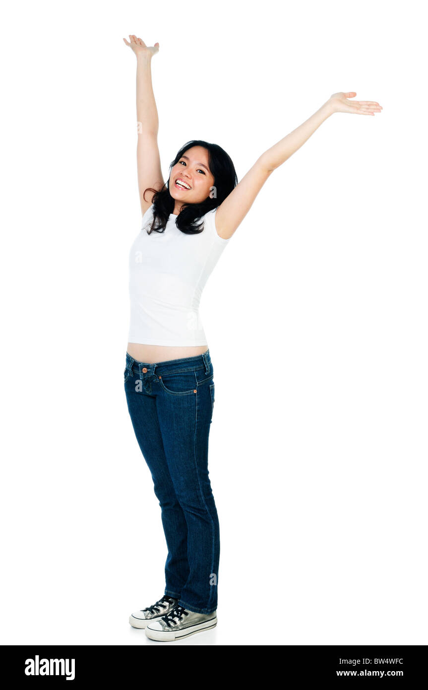Cheerful young woman with arms raised Stock Photo - Alamy