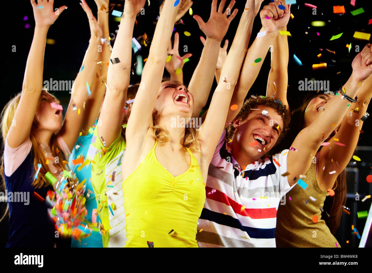 Photo of excited teenagers raising their arms in joy Stock Photo - Alamy