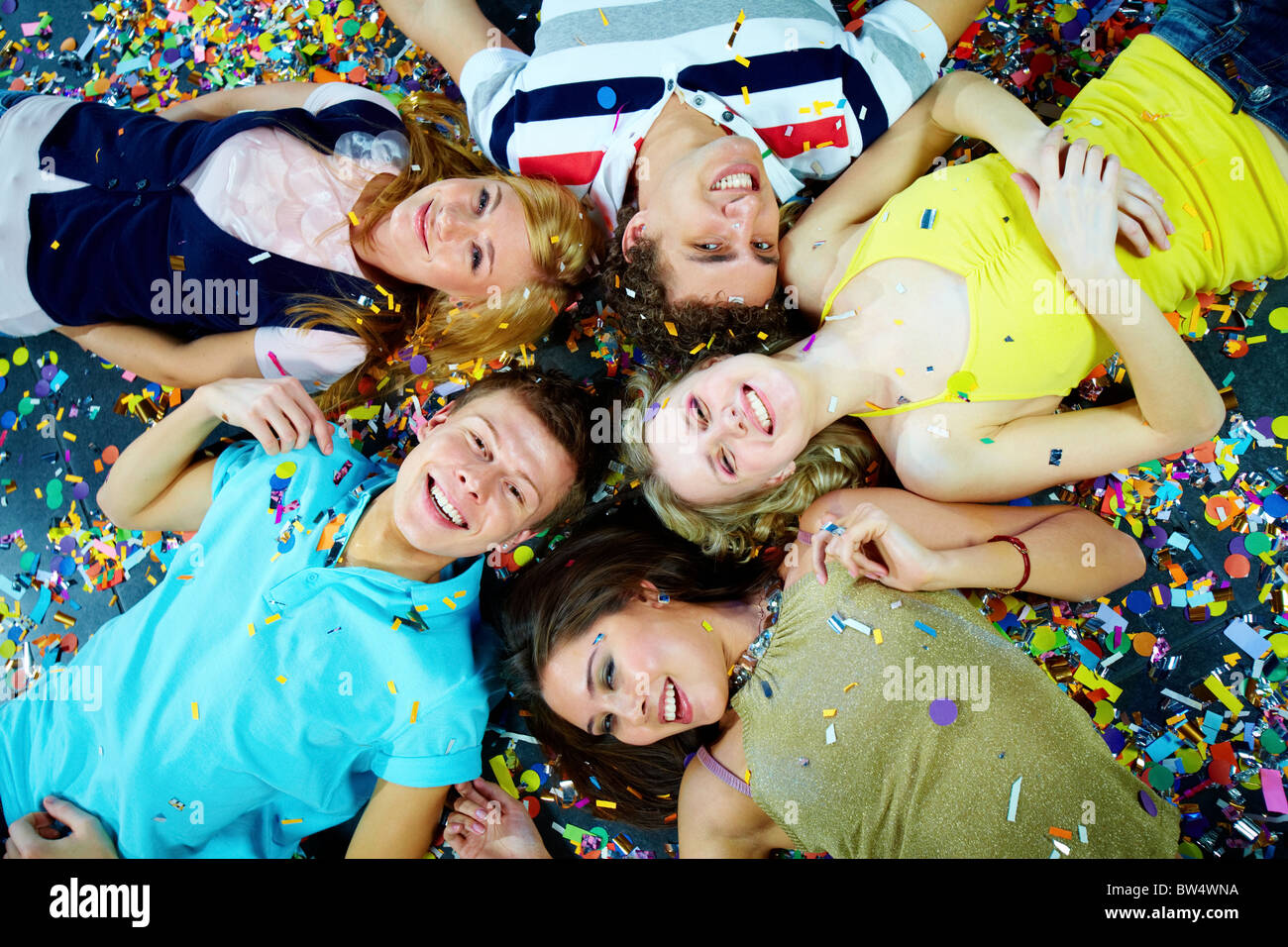 Below angle of group of happy friends looking at camera Stock Photo - Alamy