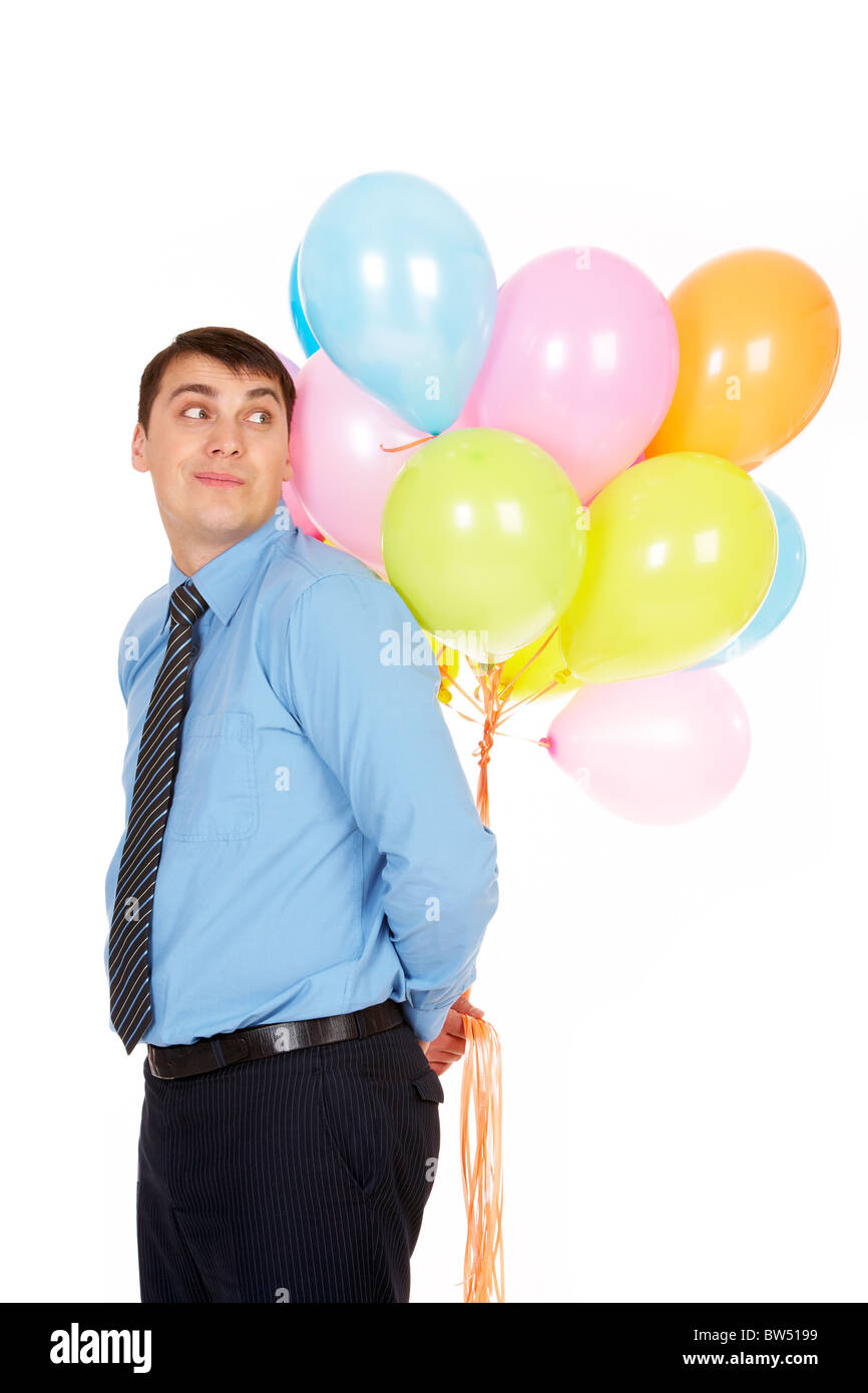 Image of successful businessman holding colorful balloons and looking ...