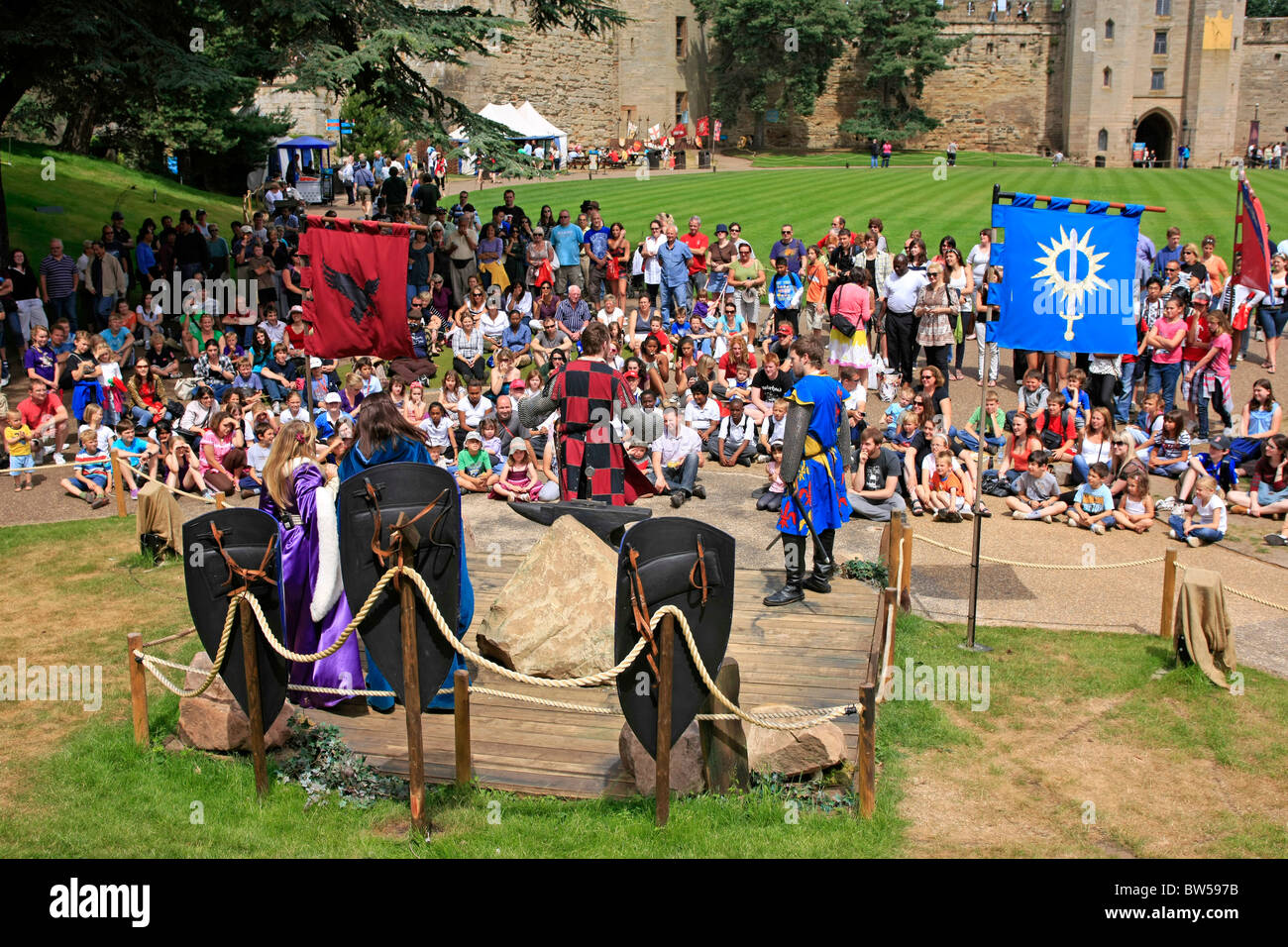 People enjoying a small play put on by the thespians at Warwick Castle ...