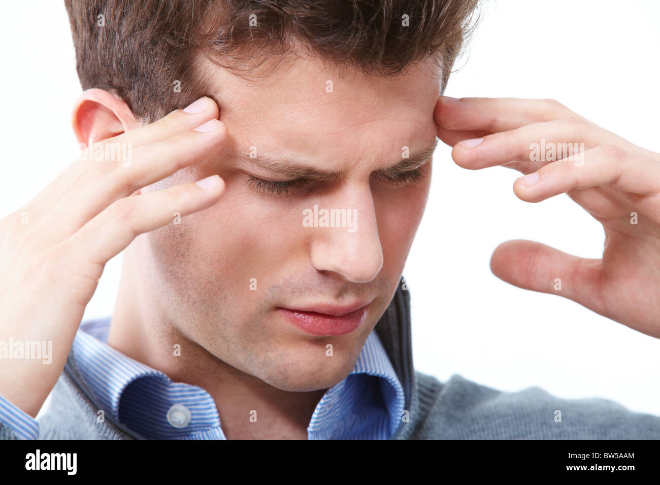 Portrait of young man having headache Stock Photo - Alamy
