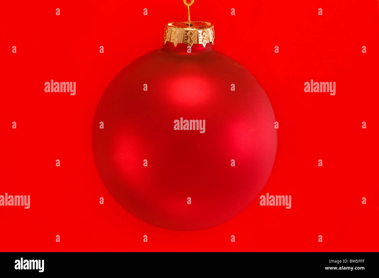 single red bauble isolated over red Stock Photo - Alamy