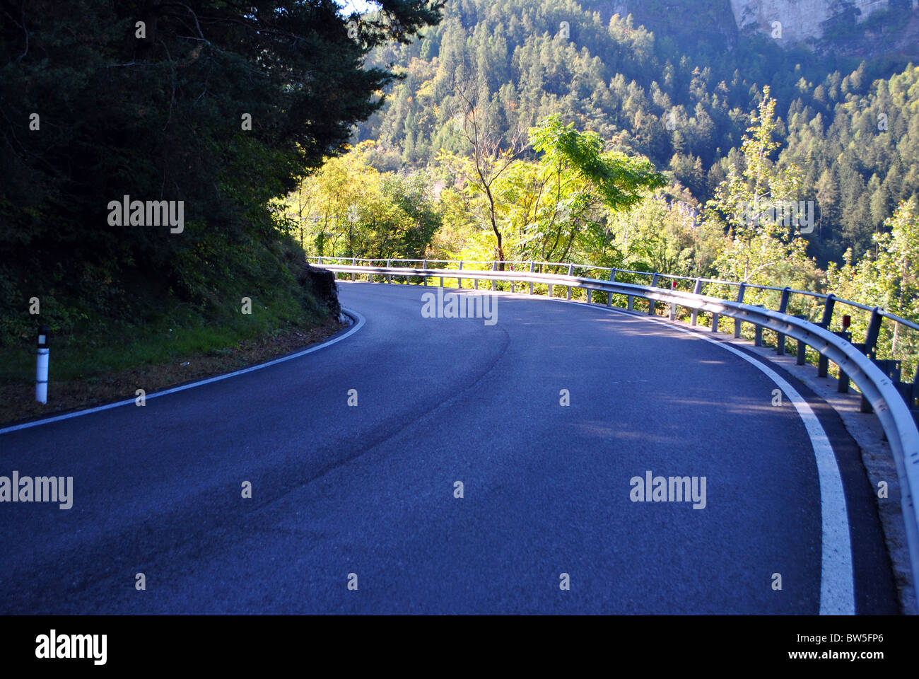 paved road with left turn Stock Photo - Alamy