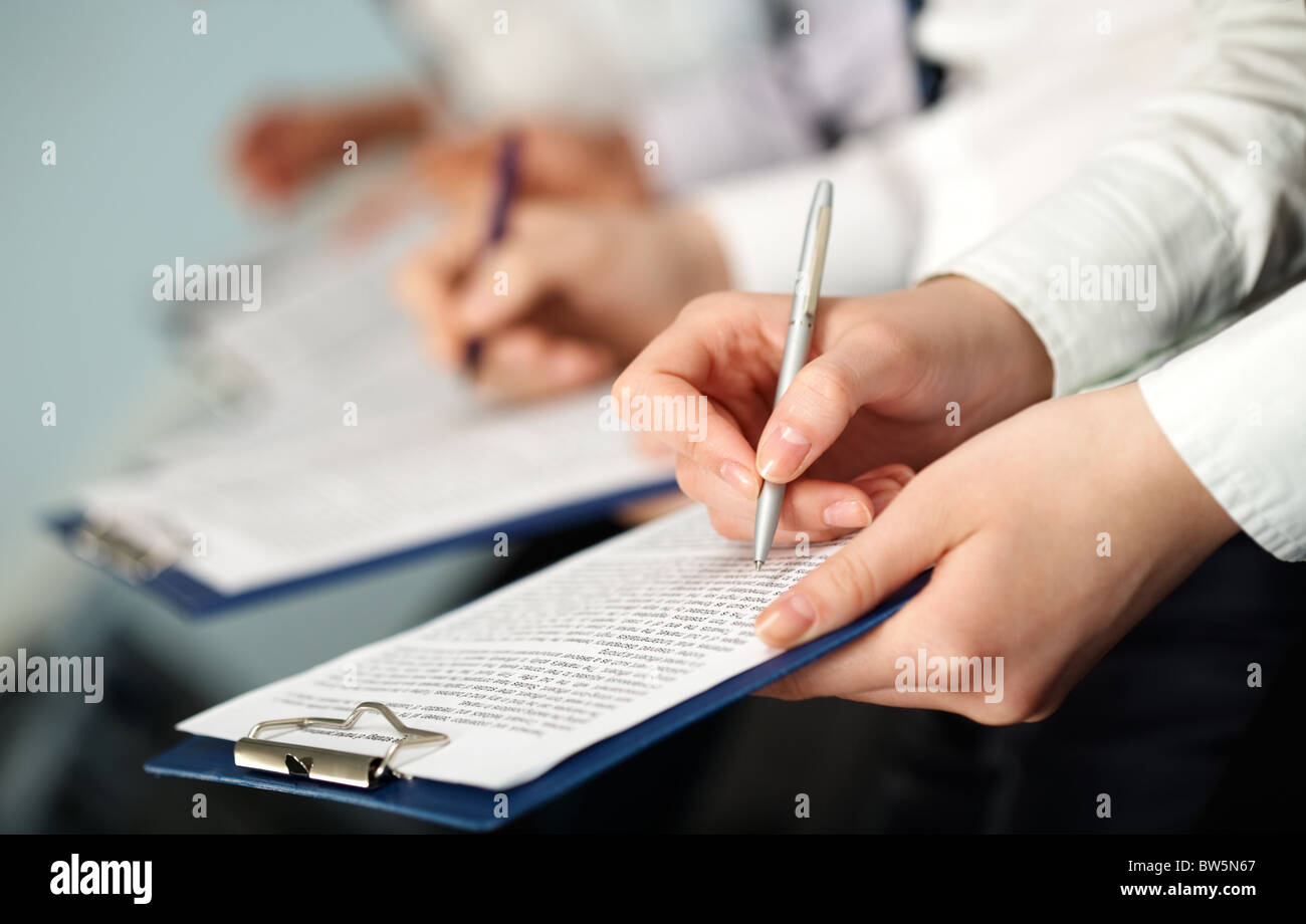 Row of hands of business people holding documents and pens Stock Photo ...