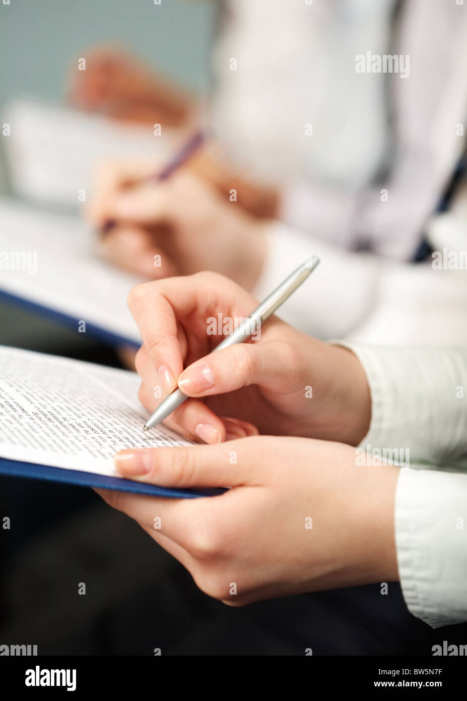 People make notes in documents at seminar Stock Photo - Alamy
