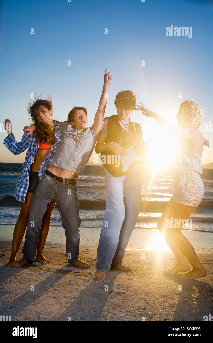 Young group with guitar dance at beach Stock Photo - Alamy