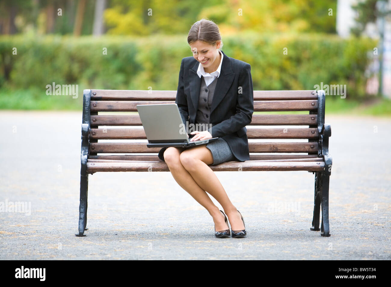 Image of elegant employer sitting on the bench Stock Photo - Alamy