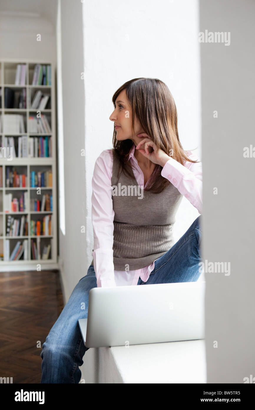 Woman looking back to someone Stock Photo - Alamy