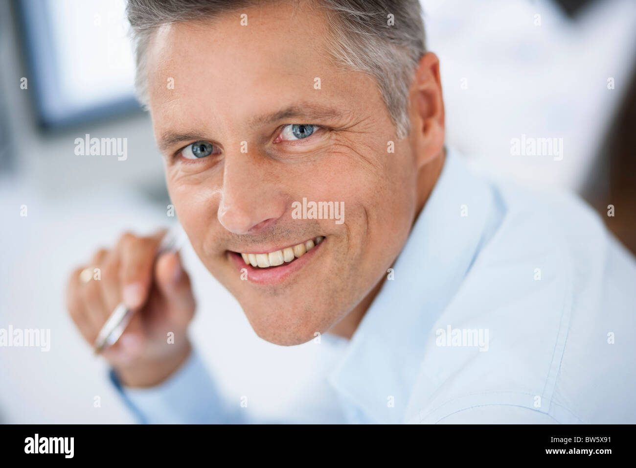 Businessman looking up to camera Stock Photo - Alamy