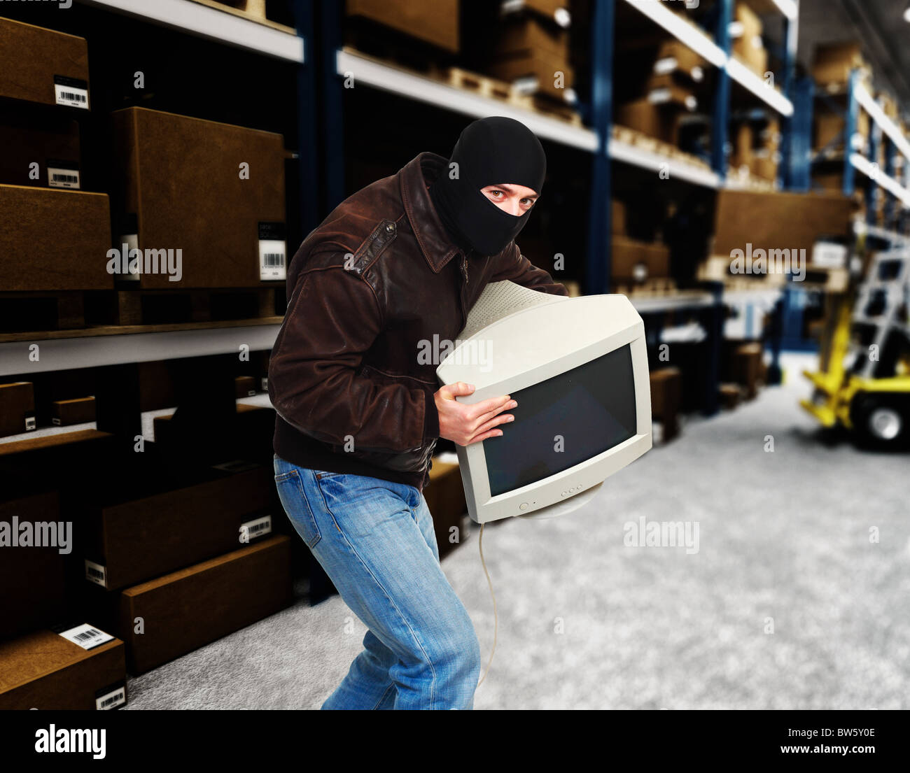 thief hold pc monitor in classic warehouse Stock Photo - Alamy