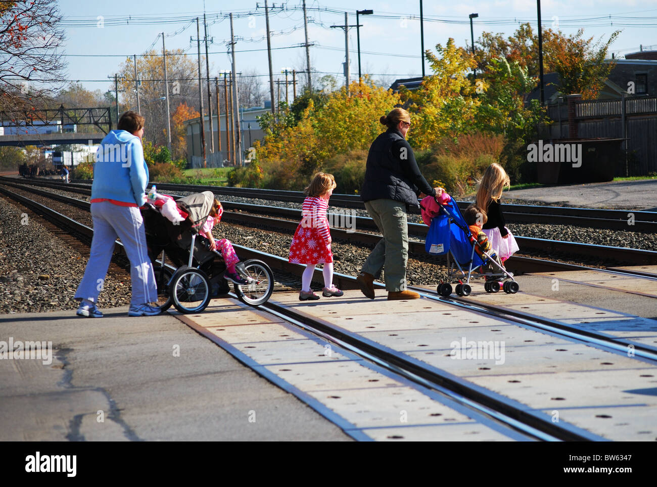 Women and children cross railroad tracks Stock Photo - Alamy