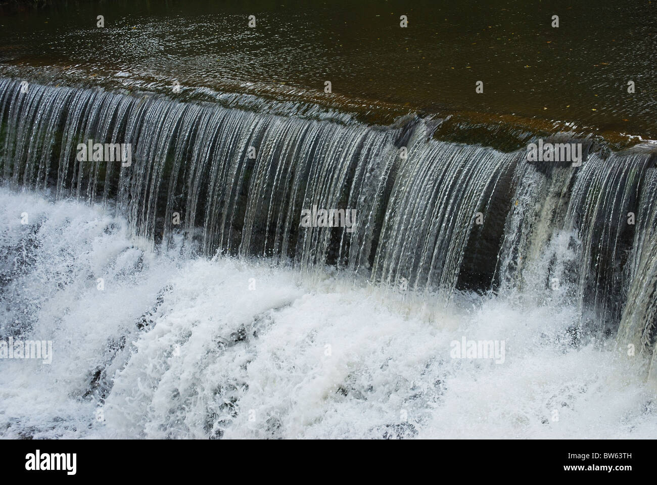 Water falls over rocks ledge Stock Photo - Alamy