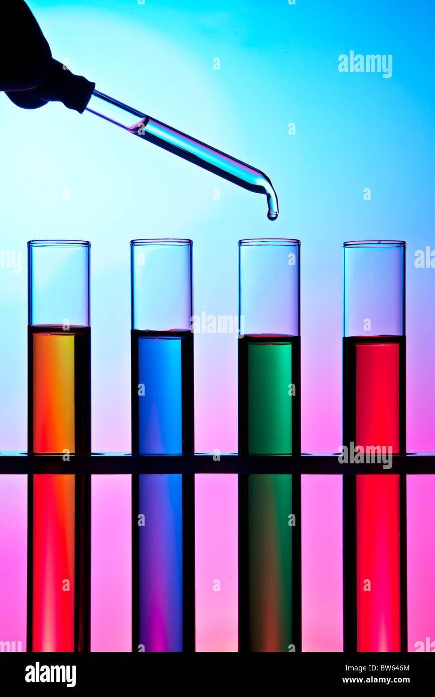Row of test tubes and dropper against a colorful background Stock Photo ...
