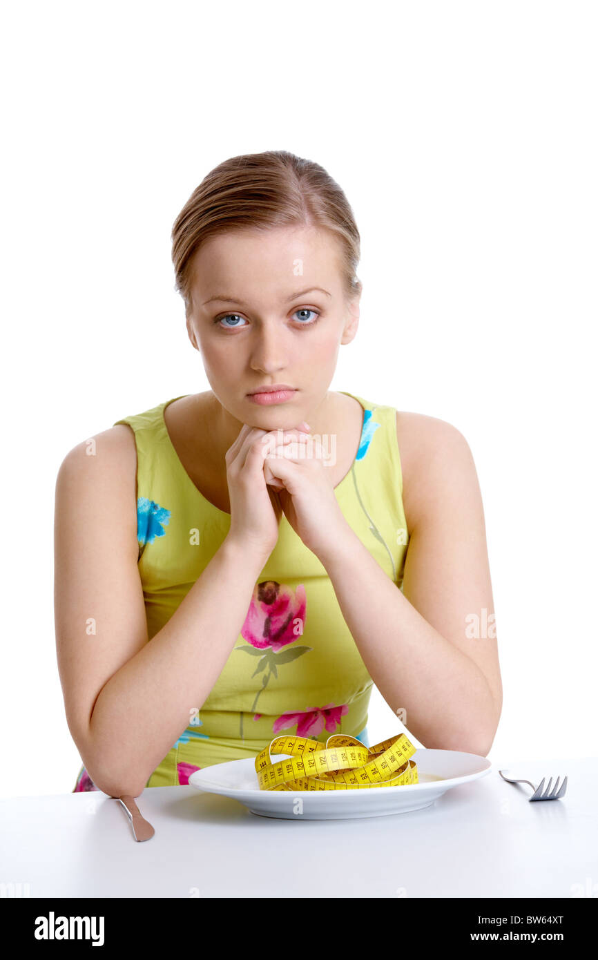Portrait of bored woman looking at camera with plate containing ...