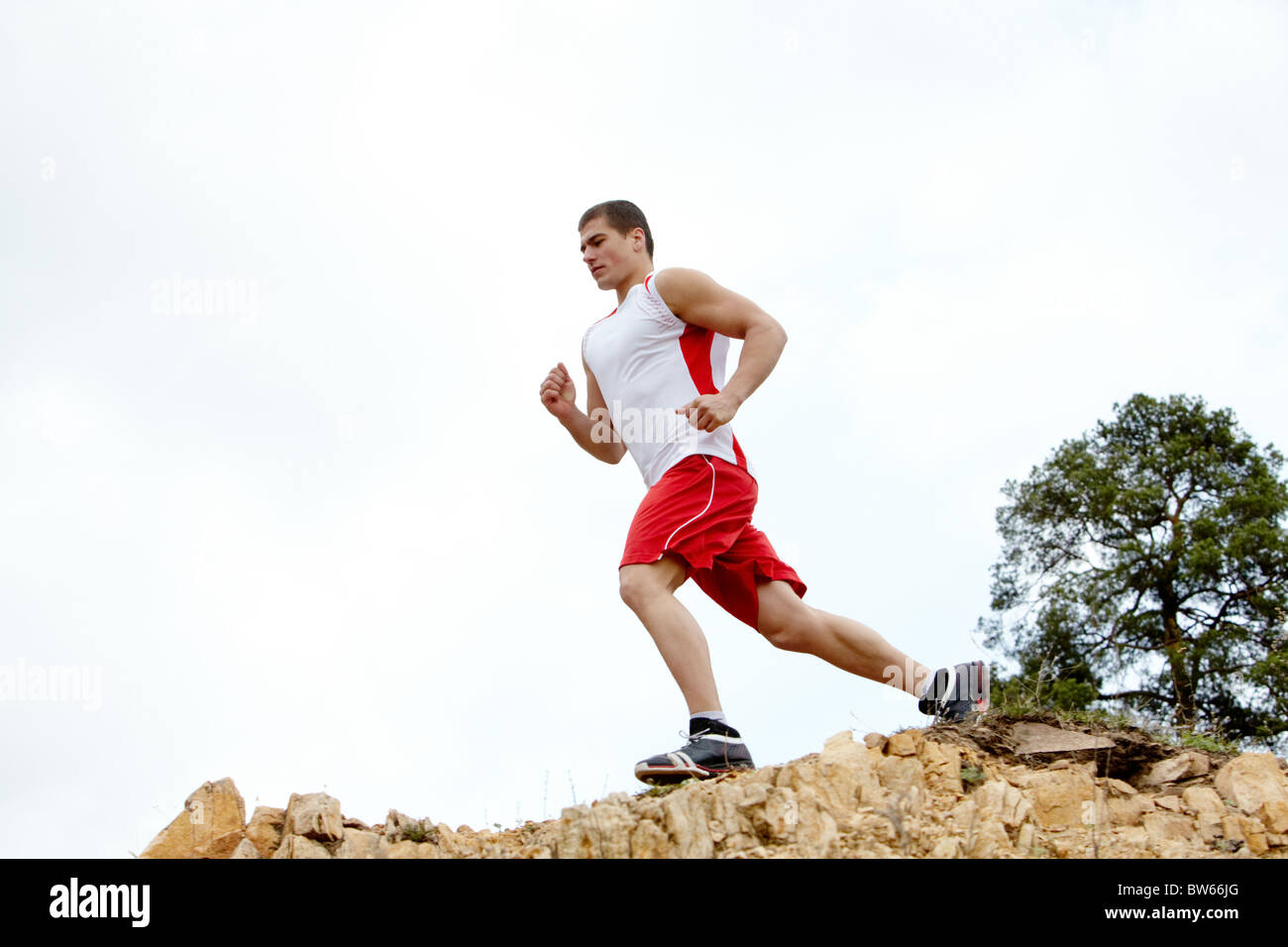 Image of healthy athlete running down cliff Stock Photo - Alamy