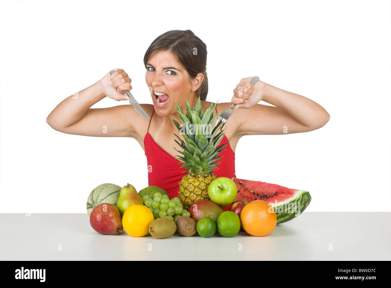Beautiful hungry woman eating a lot of healthy fruits Stock Photo - Alamy