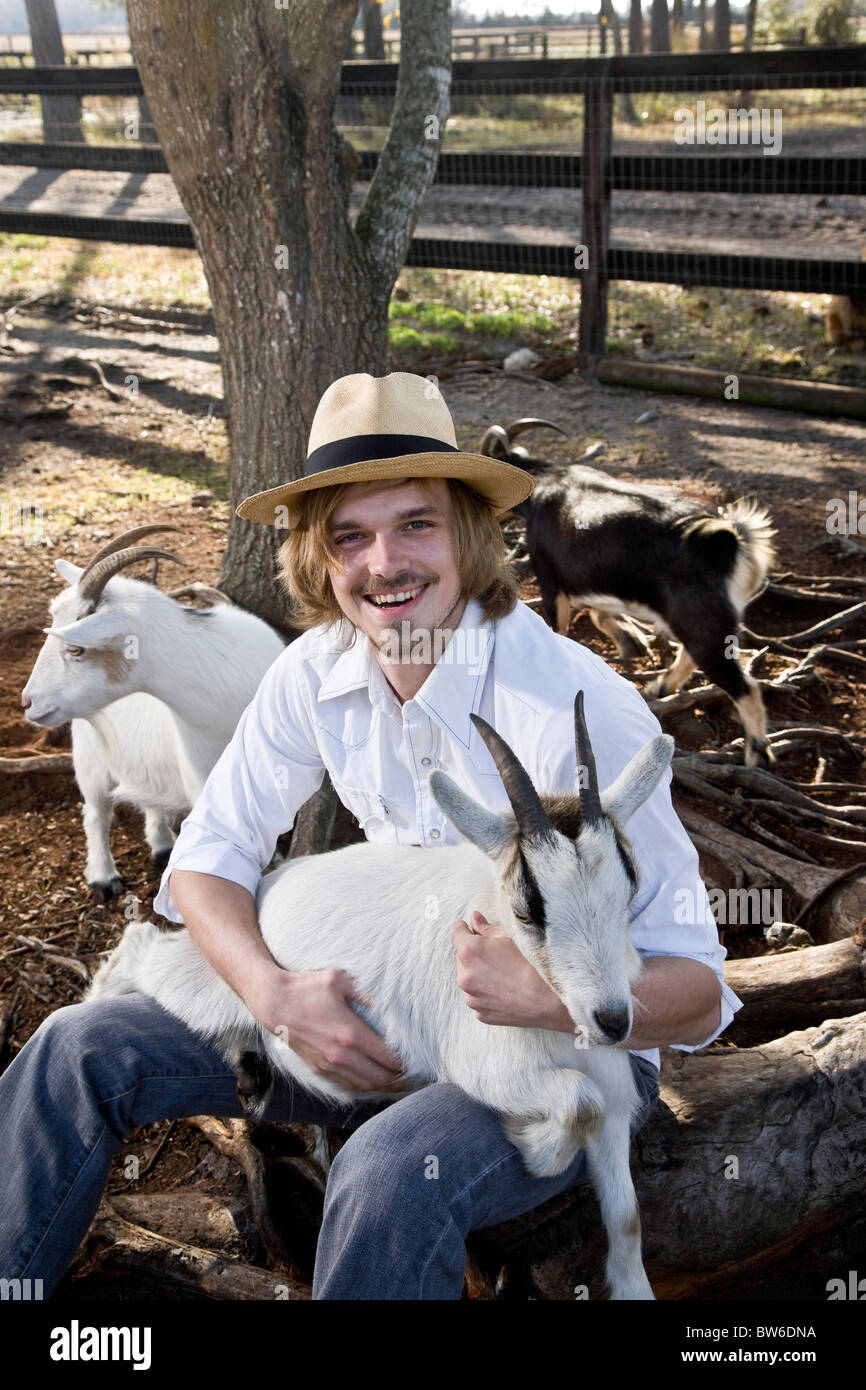 Farmer with billy goats Stock Photo - Alamy