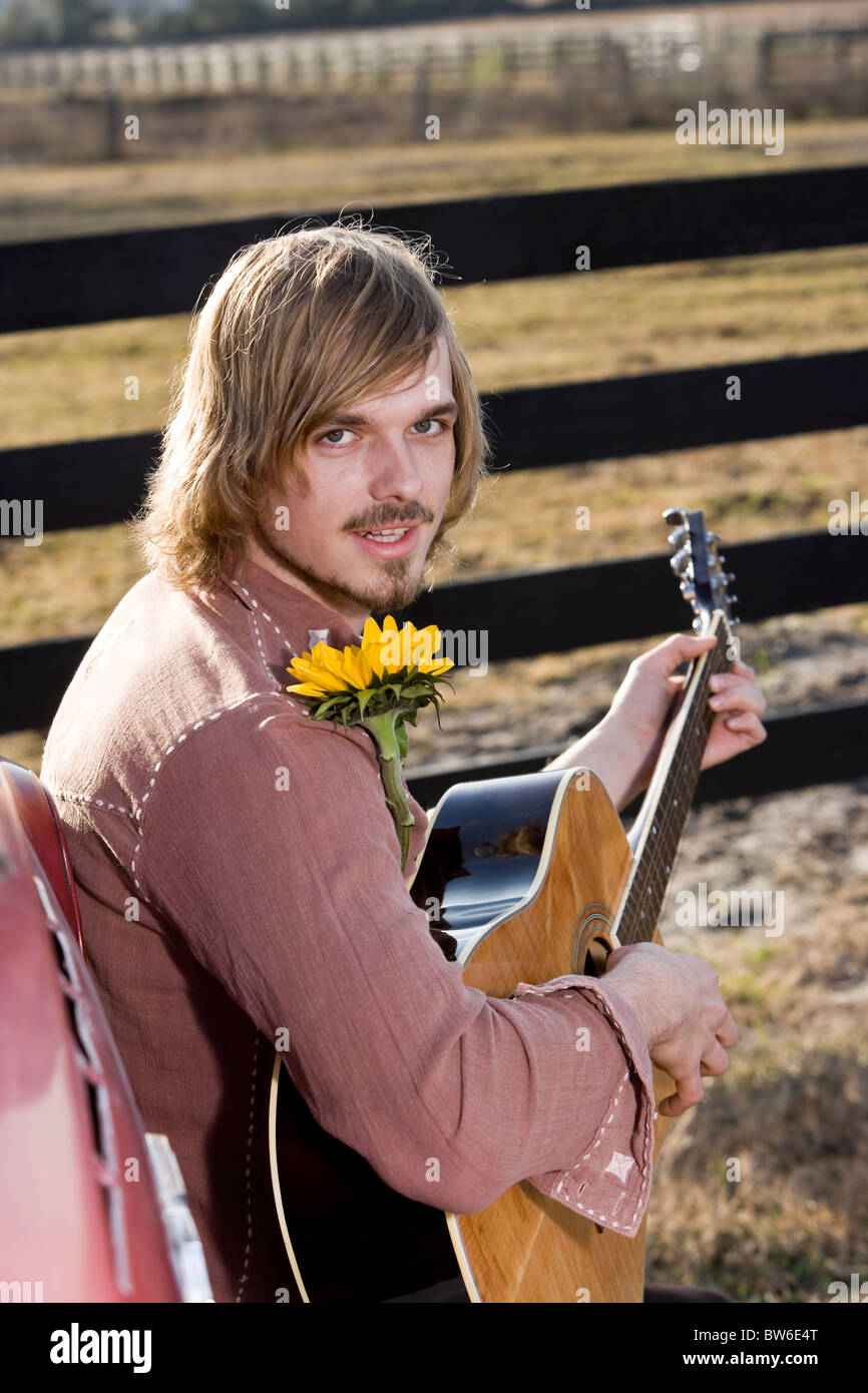 Man playing guitar on farm Stock Photo - Alamy