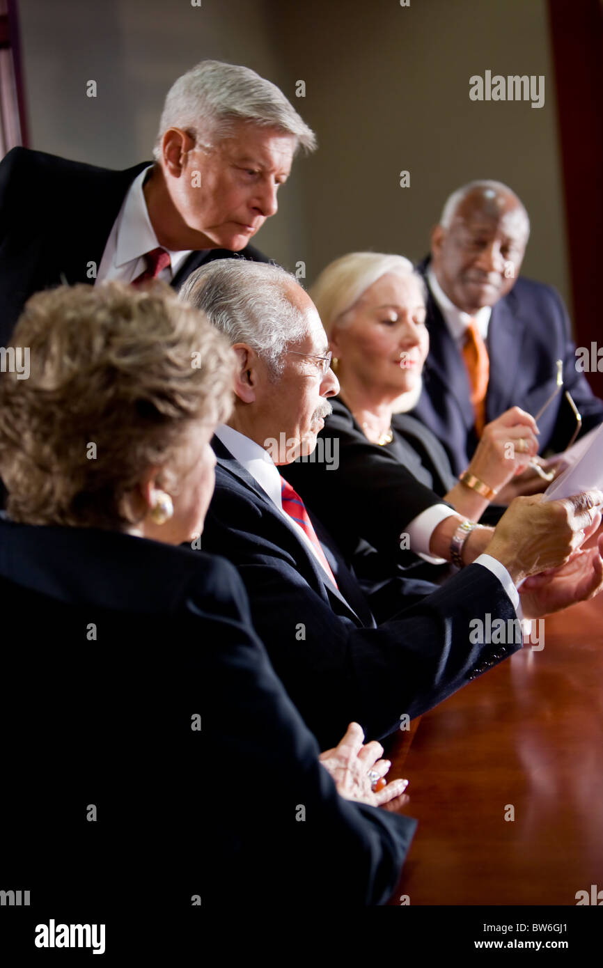 Multi-ethnic senior executives meeting in boardroom Stock Photo - Alamy
