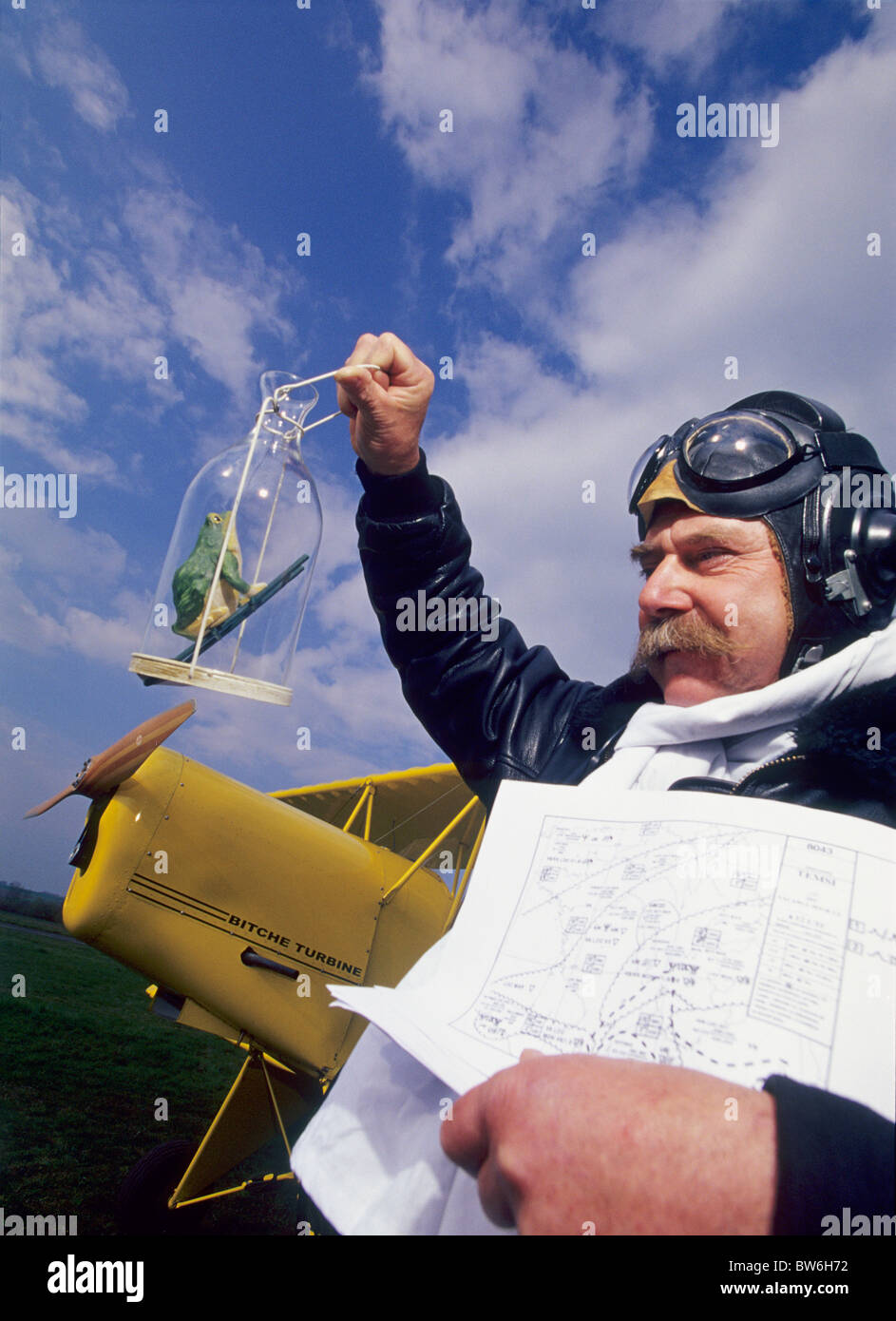 French biplane pilot checking weather forecast with a fake frog ...