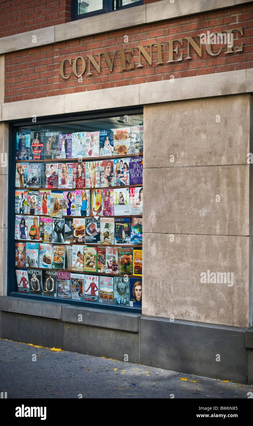 Local convenience store window magazine display Stock Photo - Alamy