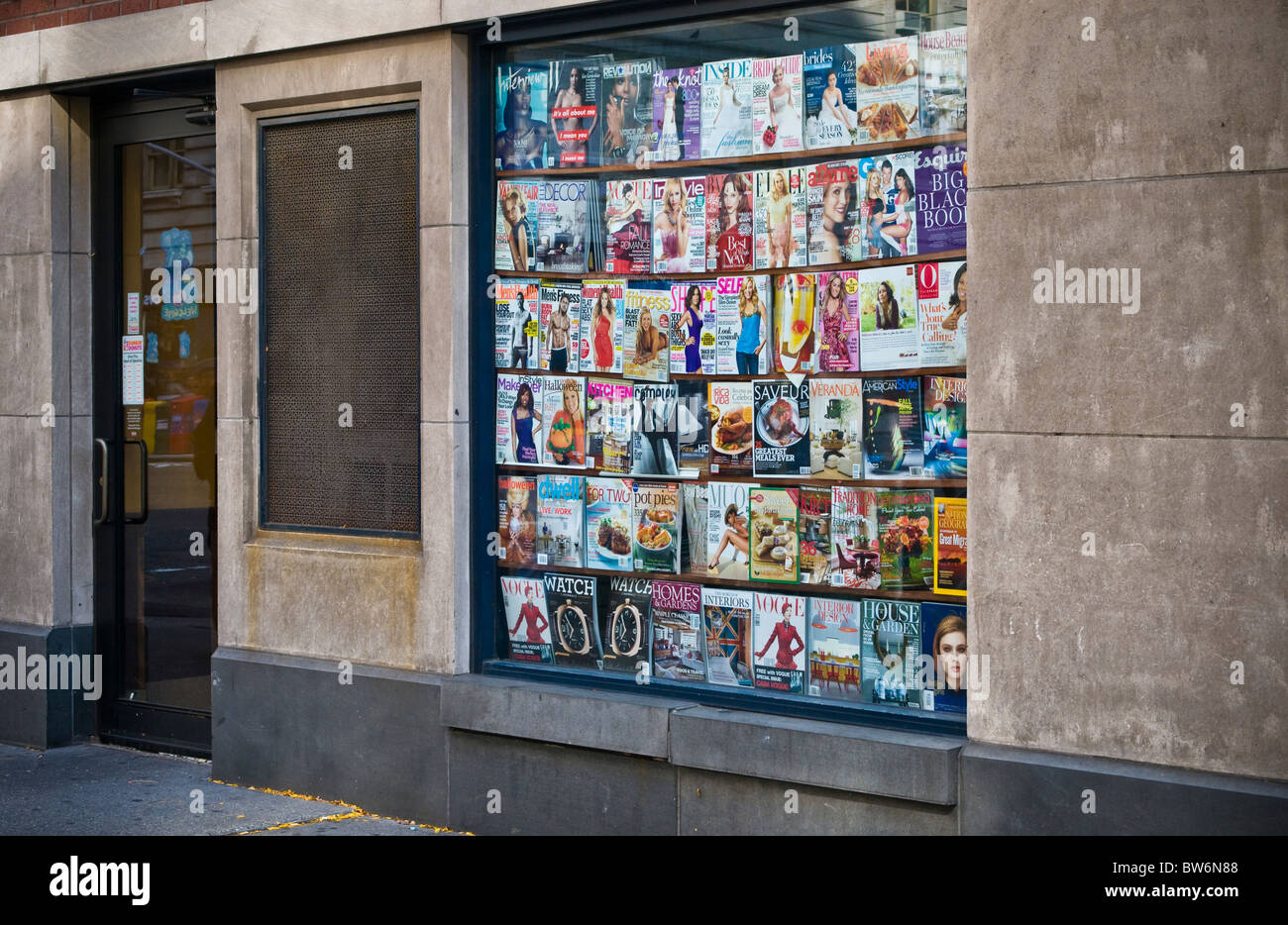 Local convenience store window magazine displa Stock Photo - Alamy