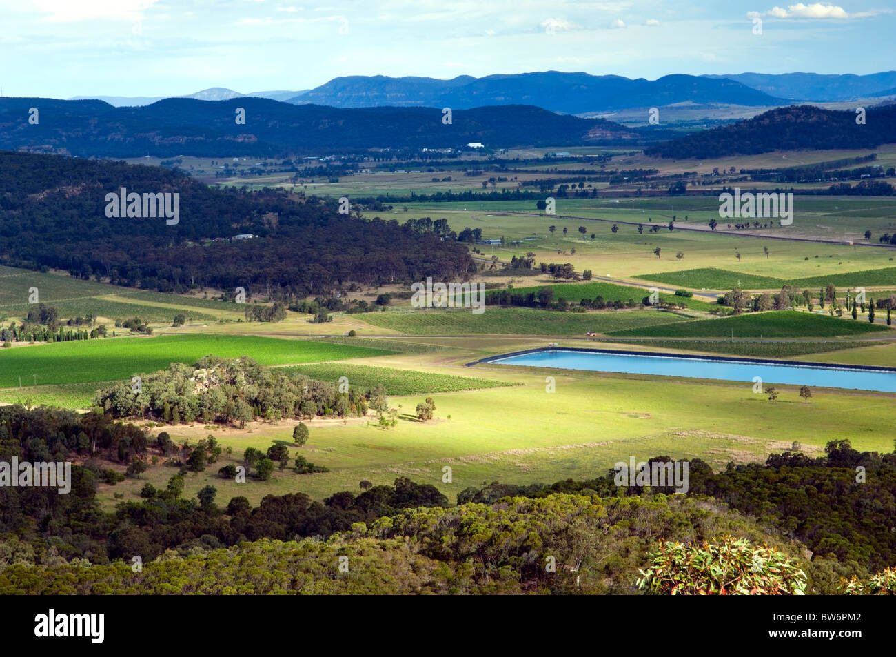 Beautiful country area with small town and brightly colored fields ...