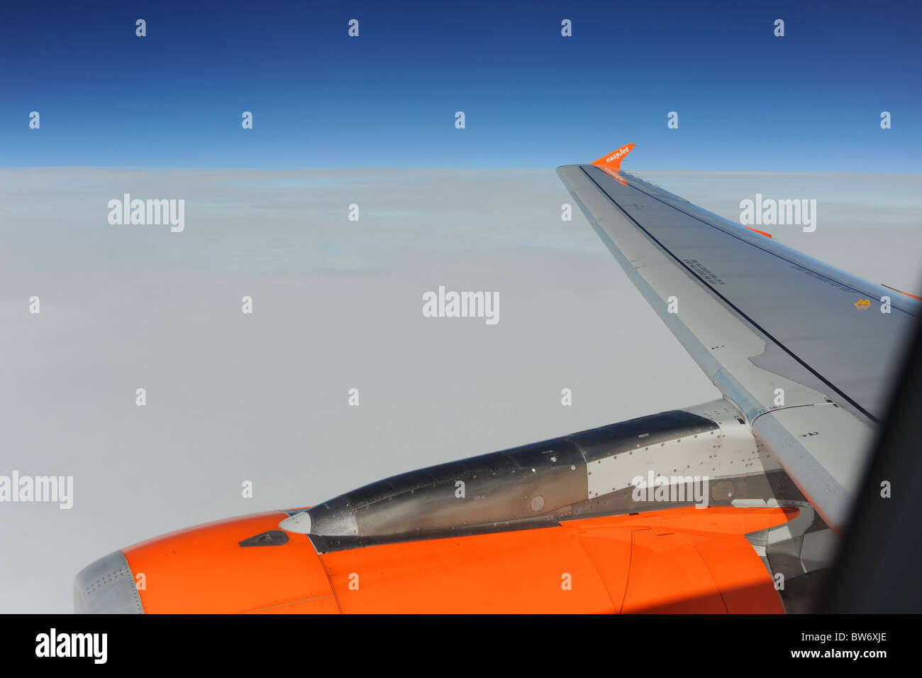 An easyJet Airbus wing above cloud against blue sky Stock Photo - Alamy