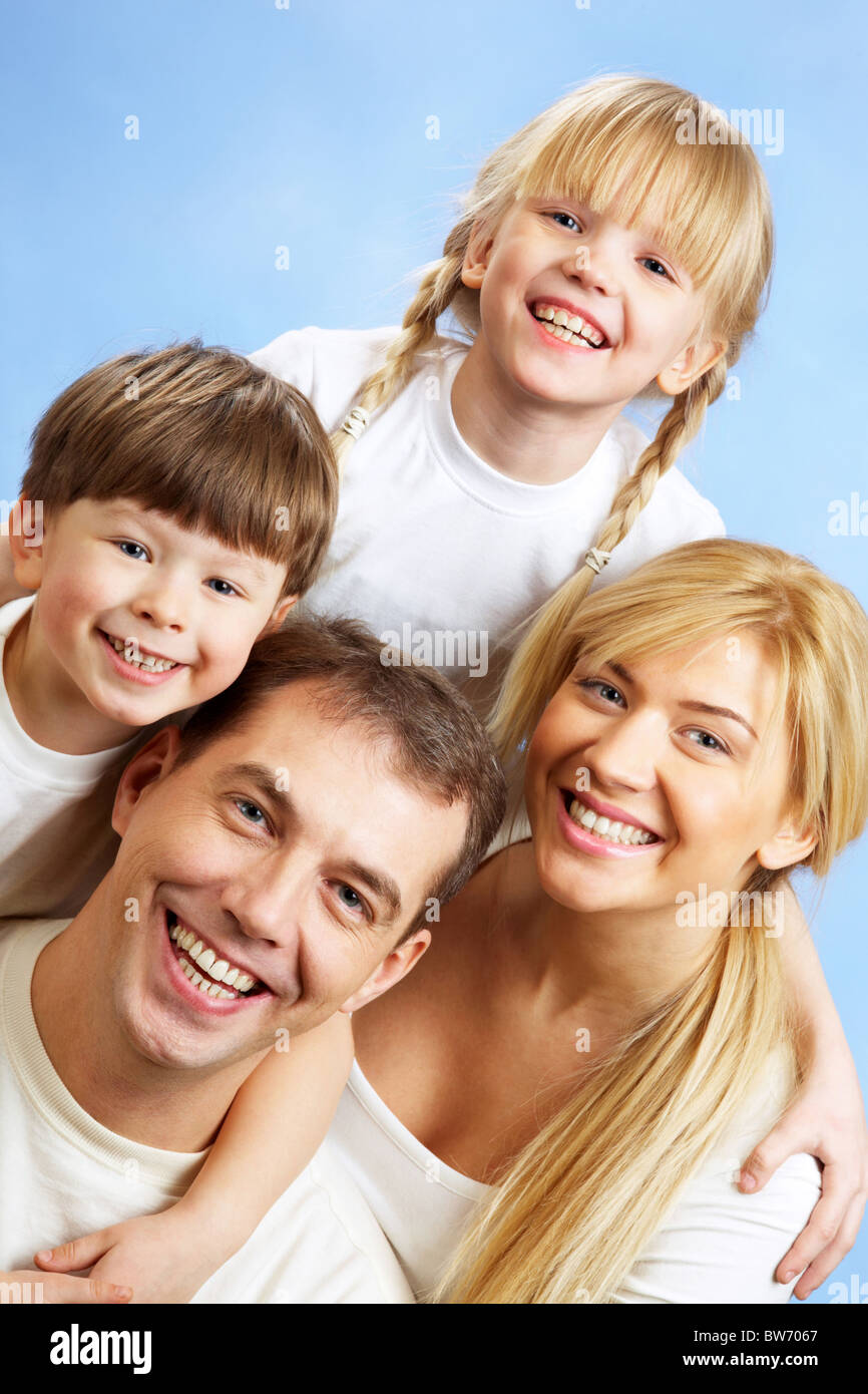 Portrait of happy family members over blue background Stock Photo - Alamy