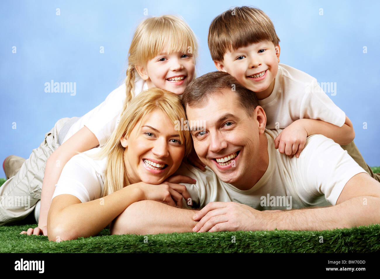 Photo of family members smiling at camera on blue background Stock ...