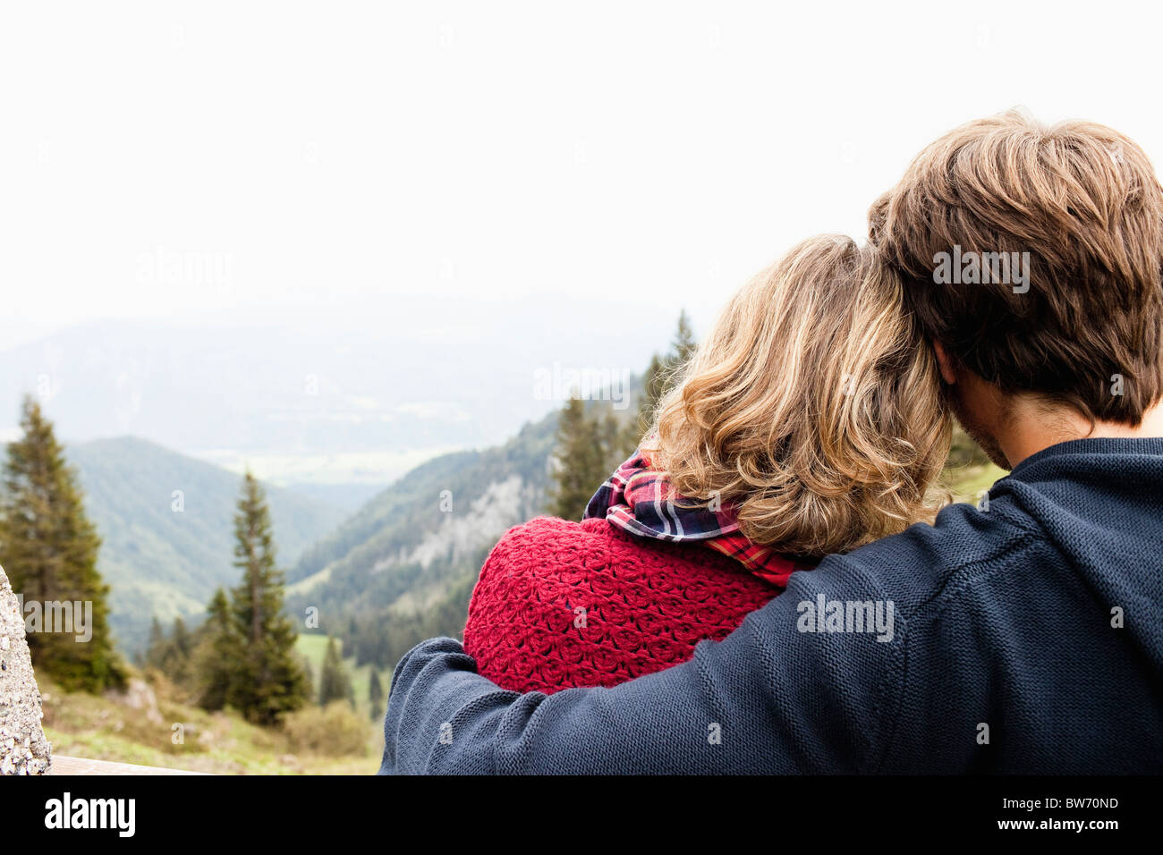Man hugging woman watching landscape Stock Photo - Alamy
