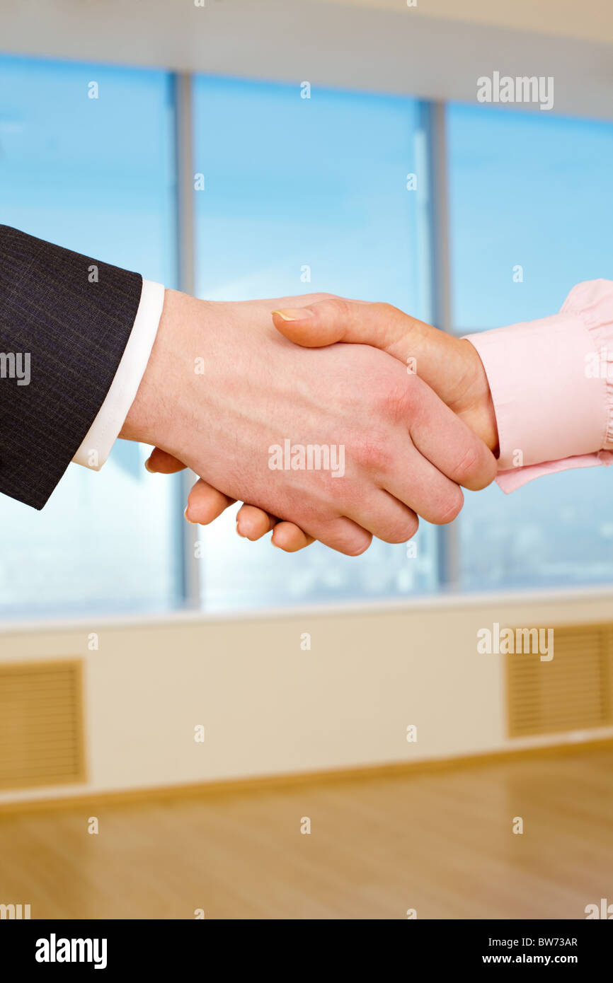 Close-up of handshake of two businesspeople after signing promising ...