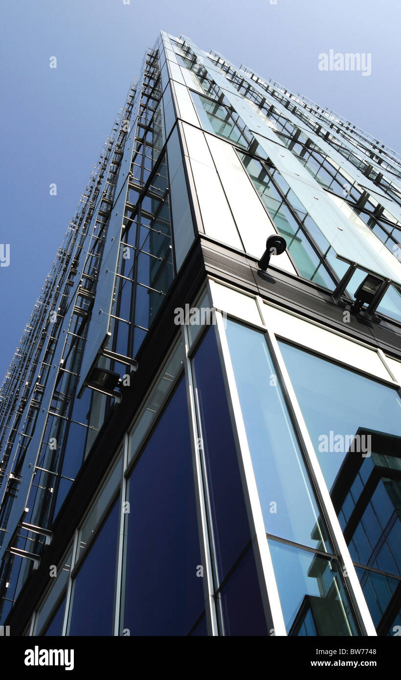 Seen from below glass fronted office building Stock Photo - Alamy