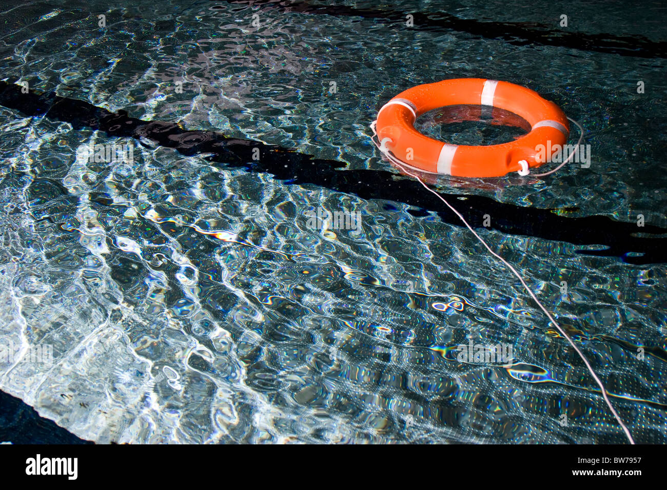 Lifebuoy on water on swimming pool Stock Photo - Alamy