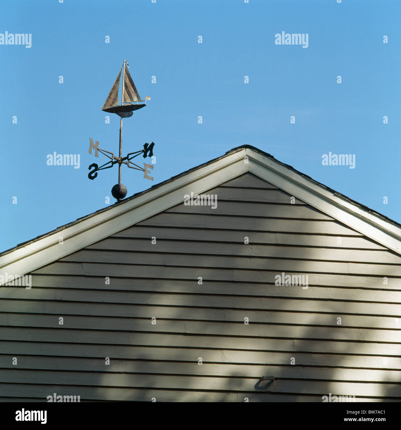 Weather-vane on pitched roof of clapboard house Stock Photo - Alamy