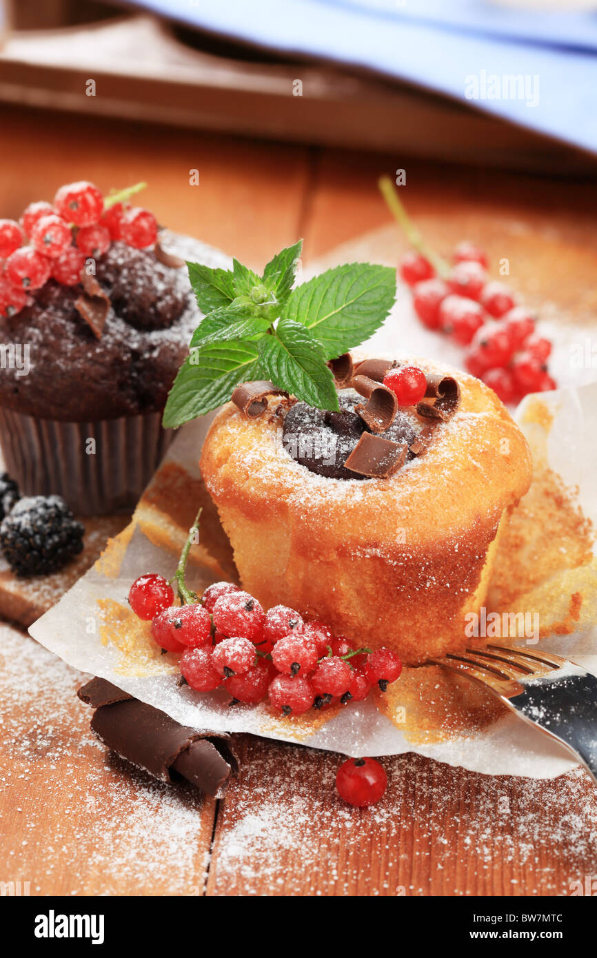 Chocolate filled sponge cake and chocolate muffin Stock Photo - Alamy