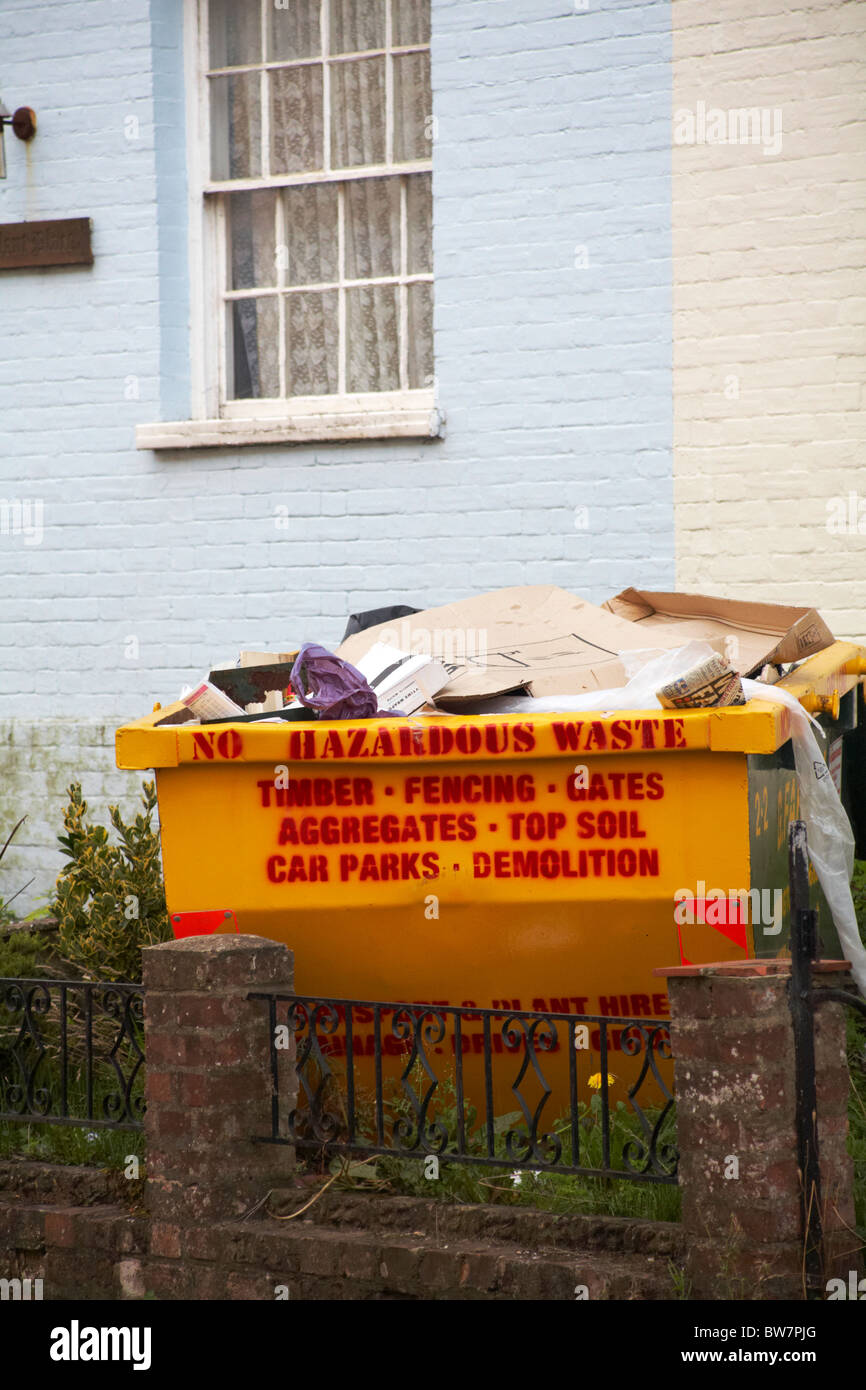Skip with rubbish in front garden of house Stock Photo - Alamy
