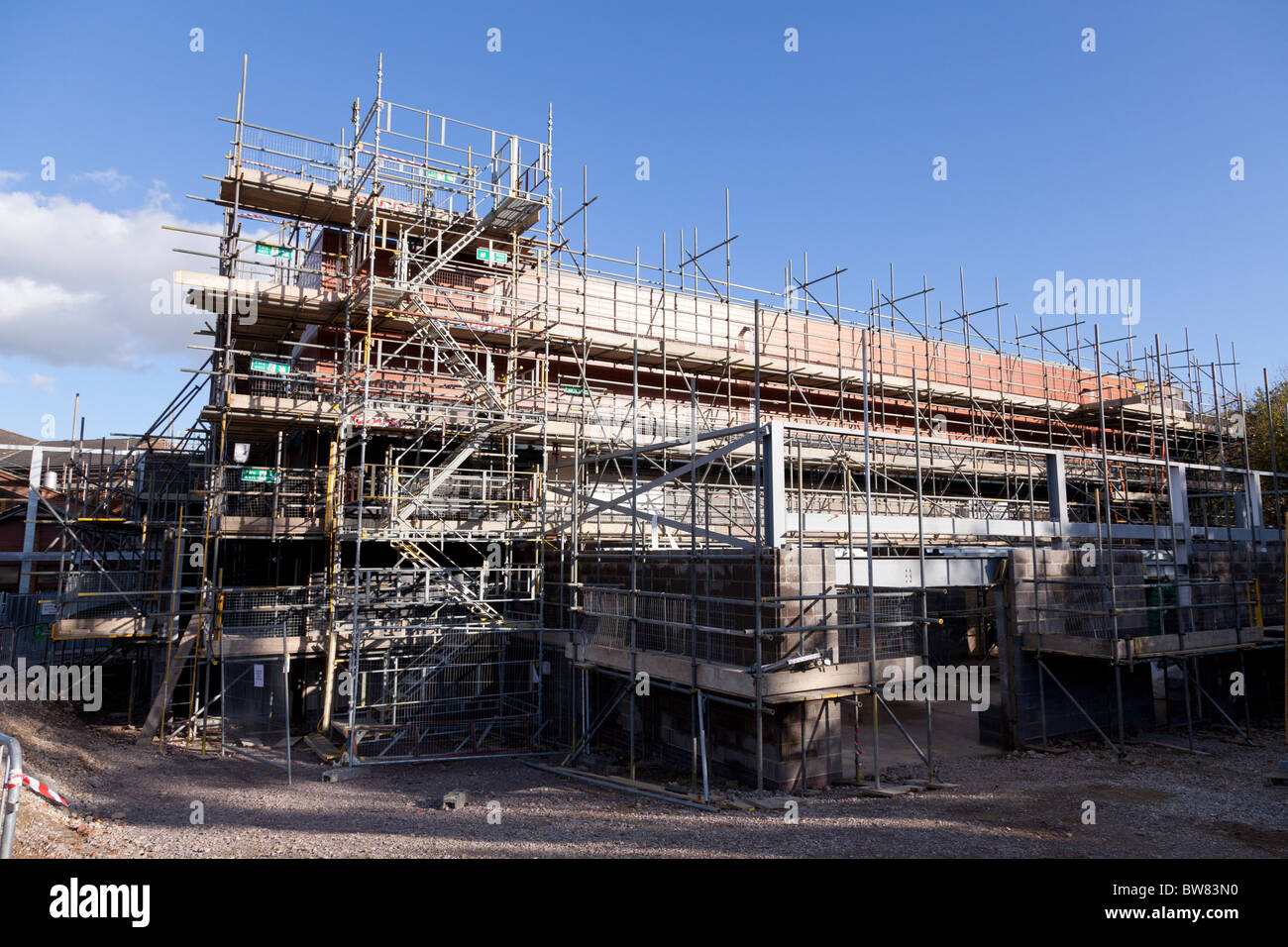 scaffolding covering new building under construction Stock Photo - Alamy