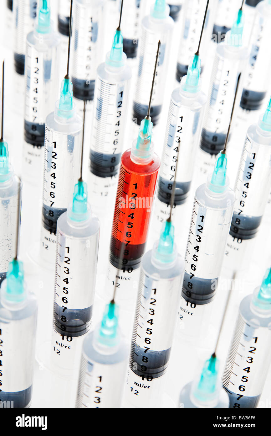 Multiple rows of syringes, one filled with blood Stock Photo - Alamy