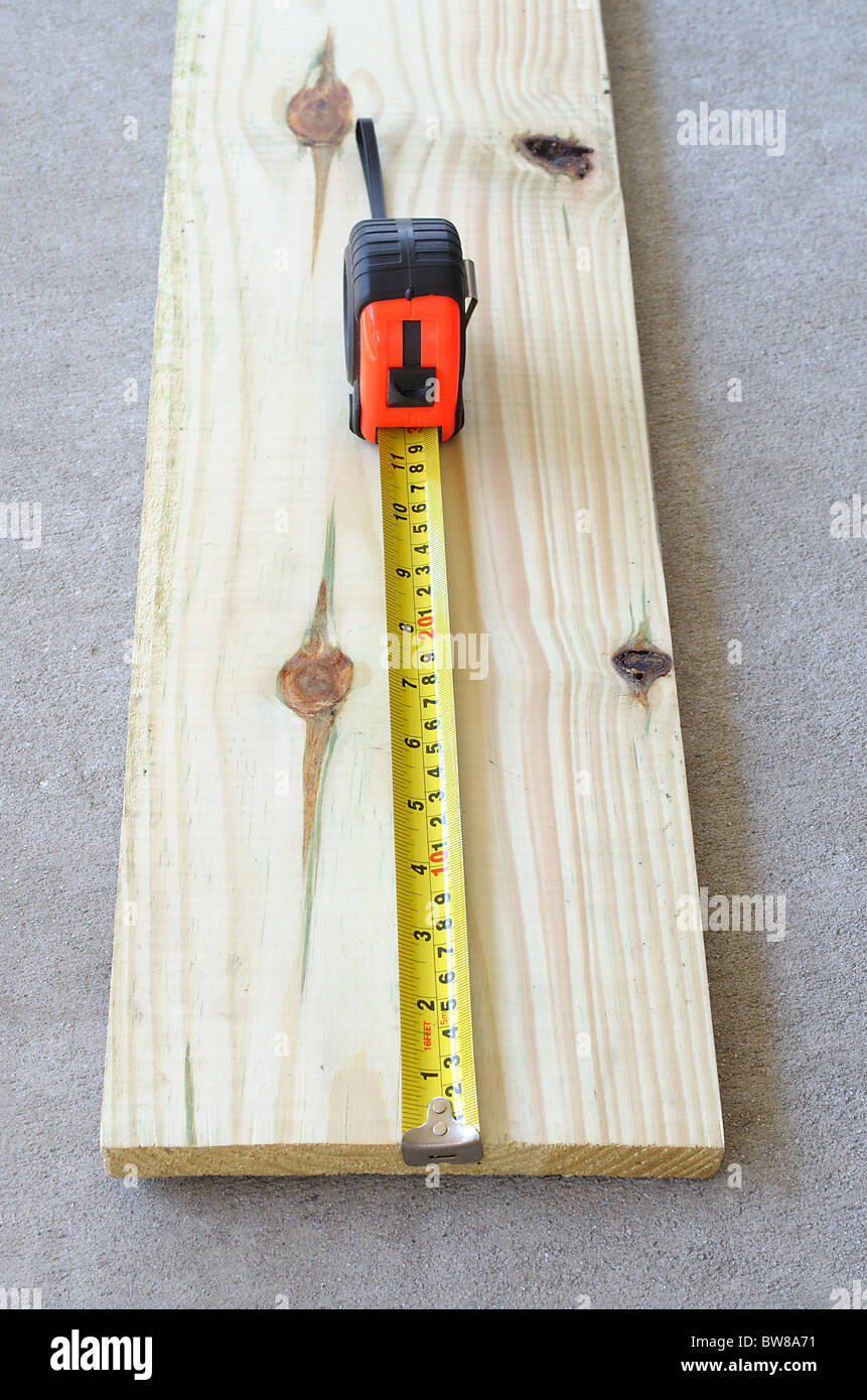Wood plank and tape measure Stock Photo - Alamy