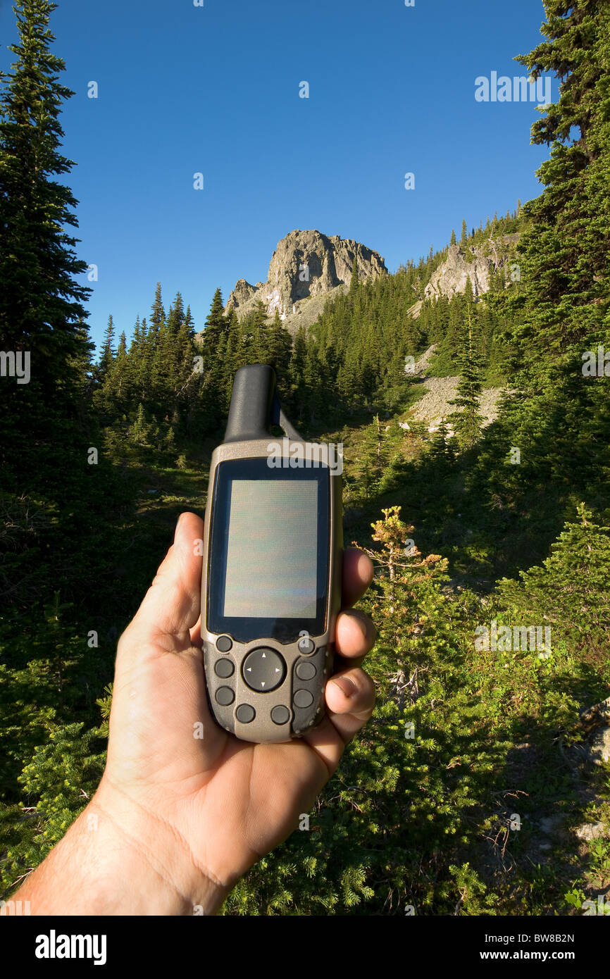 A hand holding a GPS for determining exact location Stock Photo - Alamy