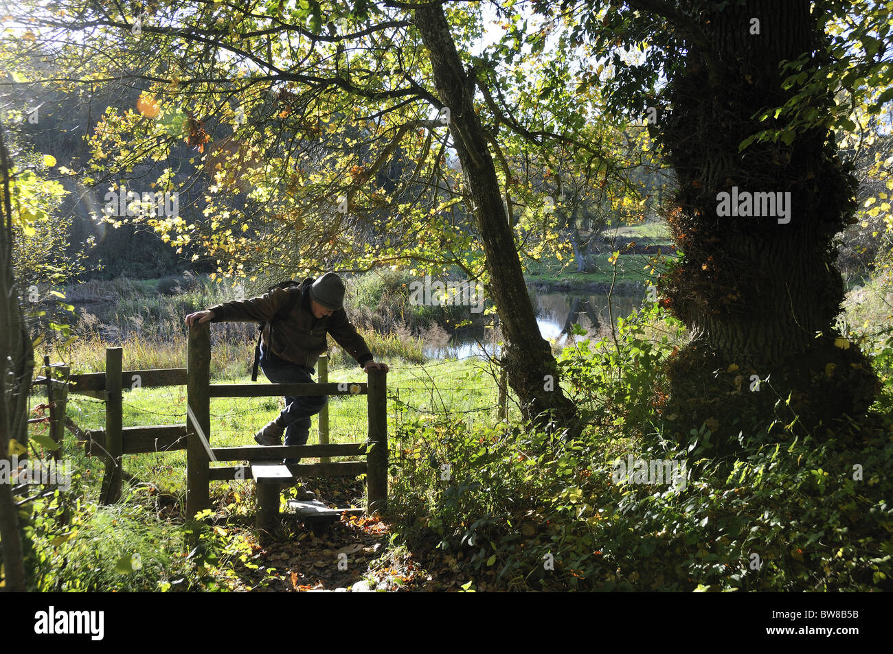 Walker climbing over stile hi-res stock photography and images - Alamy