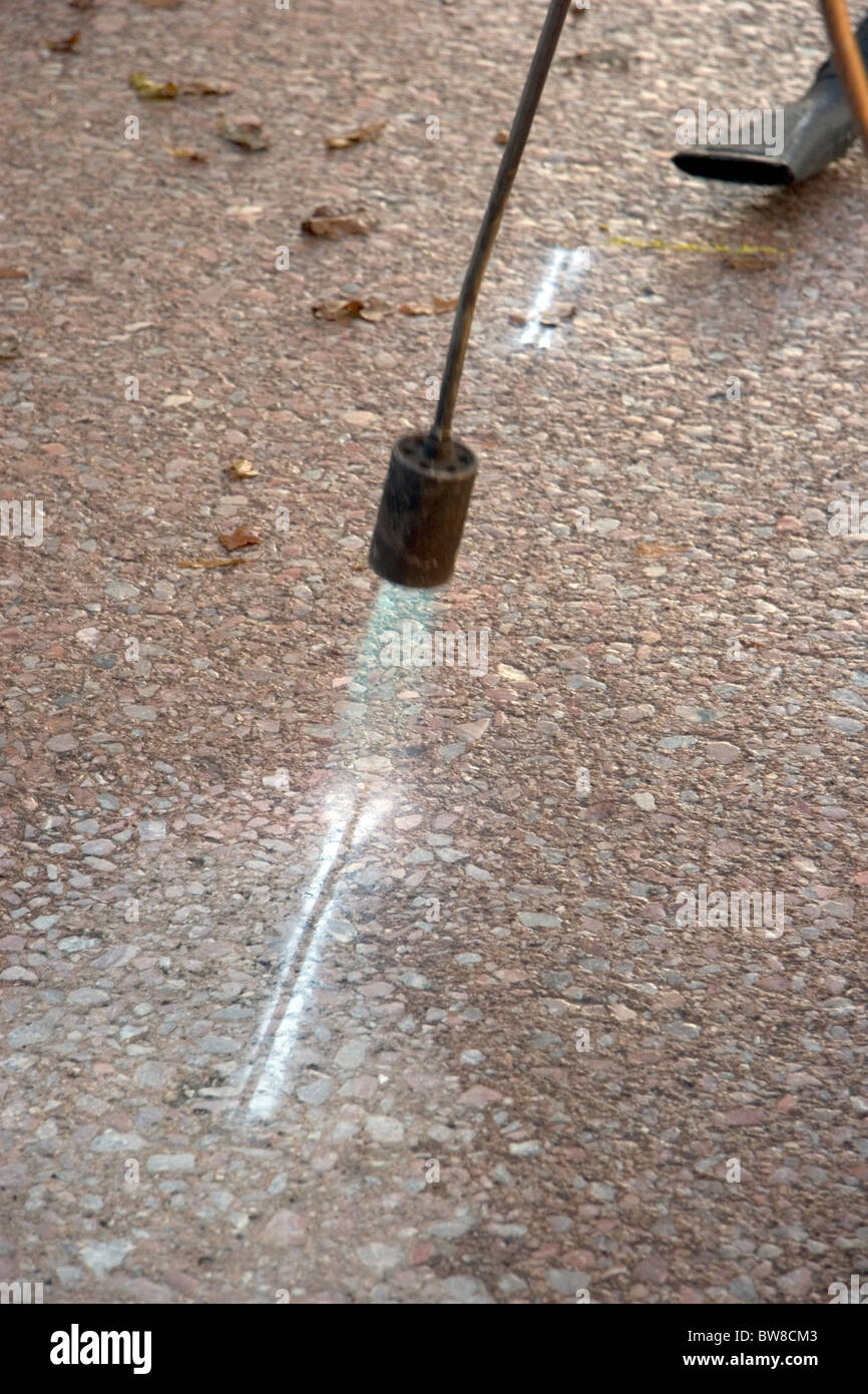 Preparing a road surface for line marking using a flame wand Stock ...