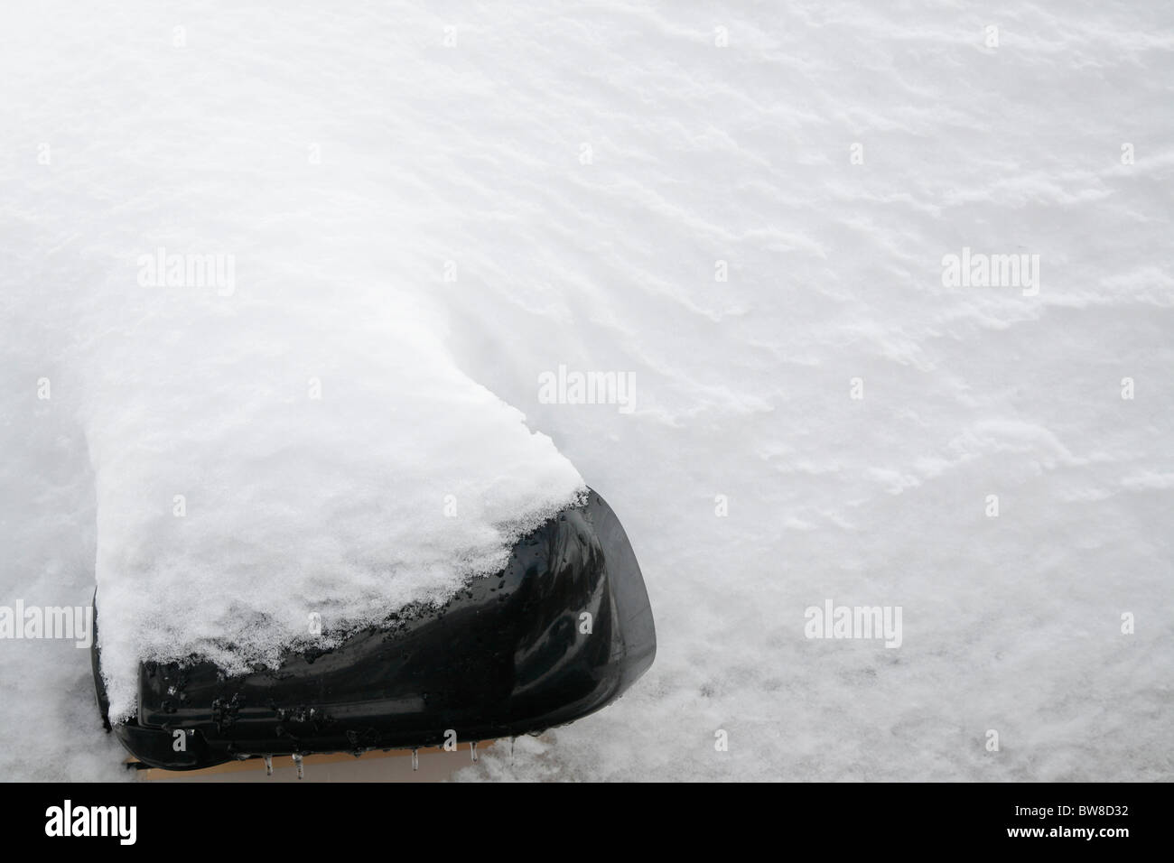 snow covered SUV car window in winter with folden in mirror showing ...